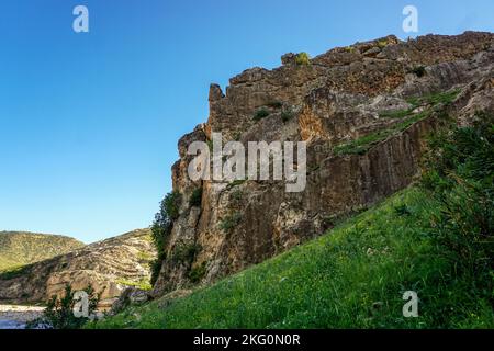 An aerial view of Cudi Gabar mountains surrounded by water under blue ...