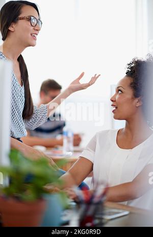 Two employees having a conversation while working together. Disabled ...