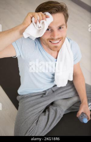 Sweaty after great work out. Handsome young men in sportswear whipping ...