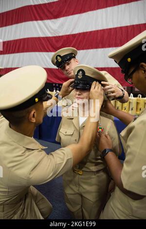 US Navy Newly pinned chief petty officers (CPOs) stand in formation ...