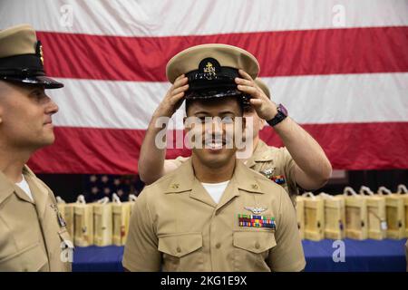US Navy Newly pinned chief petty officers (CPOs) stand in formation ...