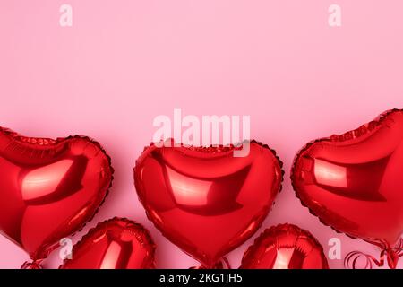 Frame made of pink inflatable foil balloons in a heart shape. Concept ...