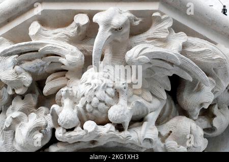 Seville Cathedral. Mother pelican feeding her little baby pelicans ...
