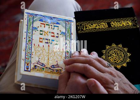 Jewish woman and muslim man reading a Torah and a Holy Bible. Couples ...