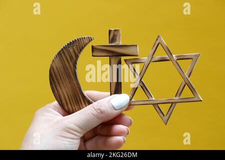 Religious symbols in hand. Jewish Star of David, Muslim star and ...