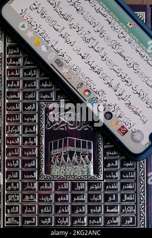 Digital Quran on a tablet and traditional Holy Quran on paper Stock ...