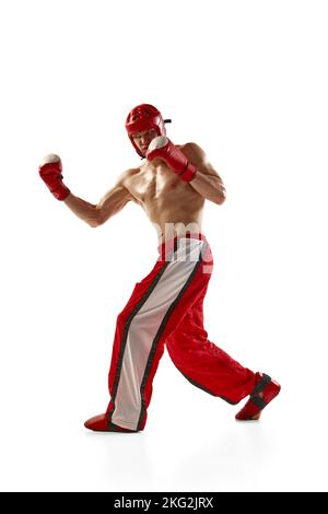 Punch. Young muscled athlete, professional kickboxer in protective ...