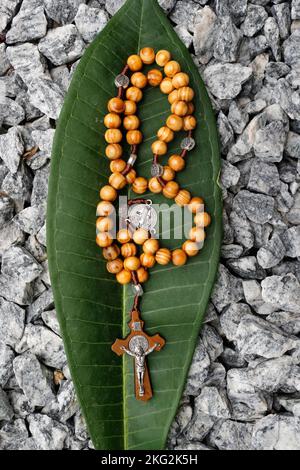 Catholic rosary on a green leaf. Religion and ecology concept Stock ...