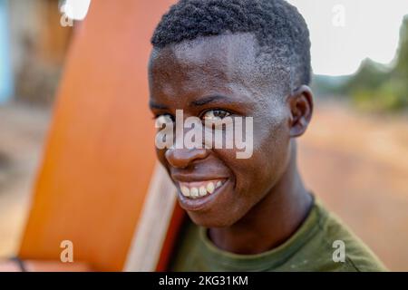 Young man pushing a bike with a heavy load in Kigali, Rwanda Stock ...