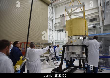 Technicians use a crane to mate the re-entry vehicle payload adapter ...