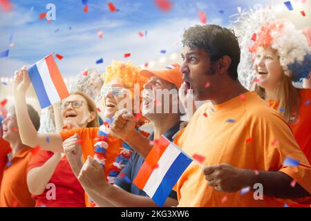 Netherlands football supporter on stadium. Dutch fans on soccer pitch ...