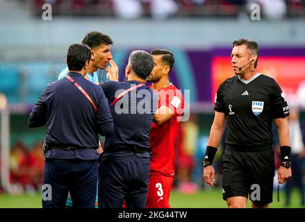 Iran goalkeeper Alireza Beiranvand receives treatment for an injury ...