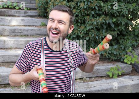 Cute male juggler practicing outdoors Stock Photo - Alamy