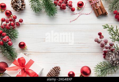 Christmas decoration with presents making a frame on a white wooden ...