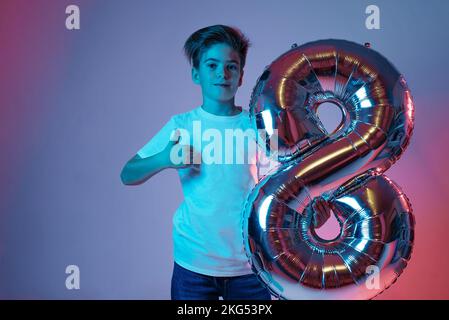 Boy with balls in the form of the number eight Stock Photo - Alamy