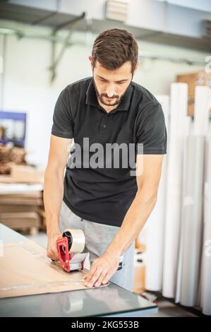 Professional worker printmaker technician operator works in printing ...