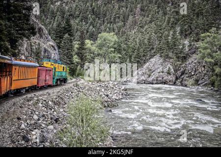 Scenic passenger train rounding a curve in a forest Stock Photo - Alamy
