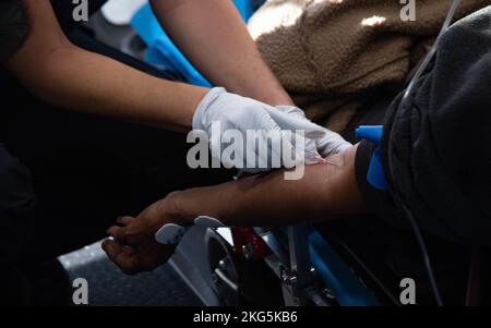 A paramedic with Fire Department 3 and Marines with Marine Transport ...