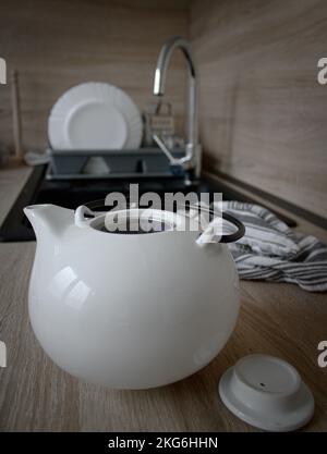 Wooden counter with ceramic sink and dishes in kitchen. Closeup Stock ...