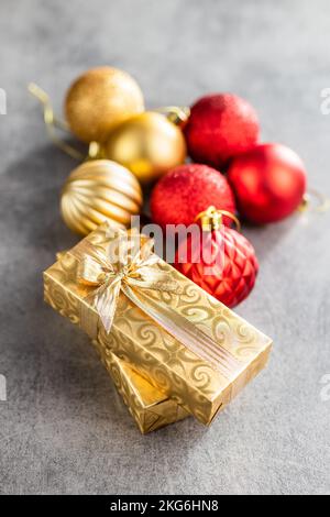 Two gold christmas gifts and christmas balls on the wooden table Stock ...
