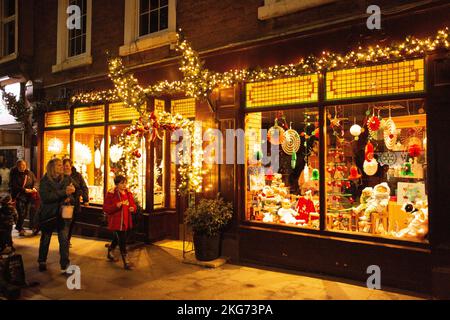 Christmas decorated shop front independant retailer with shoppers on ...