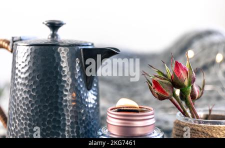 Beautiful textural teapot on a blurred background in a cozy home ...