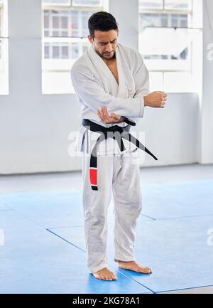 Karate, arm pain and man with injury in dojo, healthcare and fighting ...