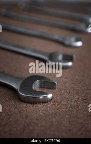 Close up of of the metallic spanners on the wooden background Stock ...