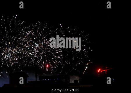 colorful fireworks at night with shadows of a construction site and ...