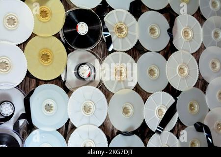 Stack of supply and take up reels with ribbon of VHS video cassette ...