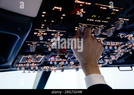 Pilot hand is controlling plane toggle switches to fly take off and ...