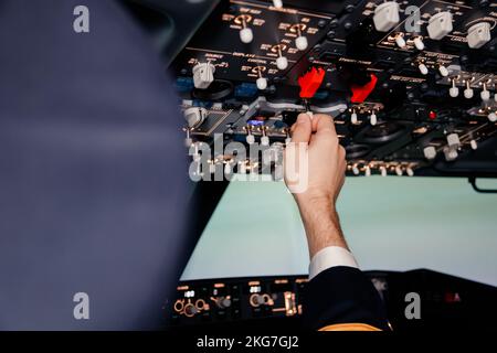 Pilot hand is controlling plane toggle switches to fly take off and ...