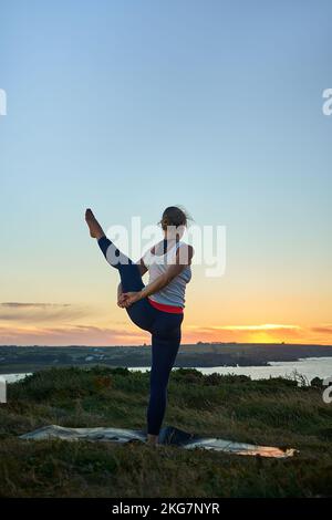 girl doing yoga outdoor, vertical Stock Photo - Alamy