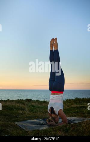 inverted yoga pose of woman performing yoga Stock Photo - Alamy