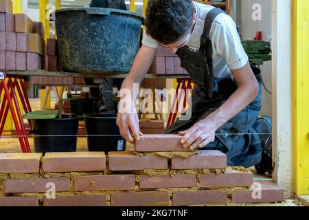 secondary school student laying bricks in masonry workshop. 2018 ...