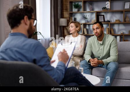 Multiracial quarrel between husband and wife at a session with a ...