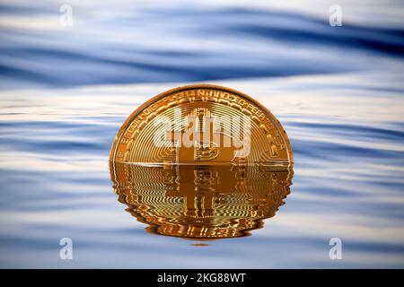 Illustrative image of a cryptocurrency coin submerged in water in ...