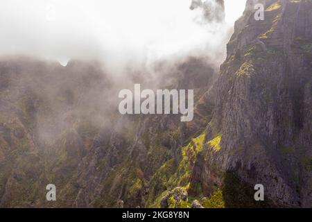Drone view of mountains buried in clouds during summer day Stock Photo ...