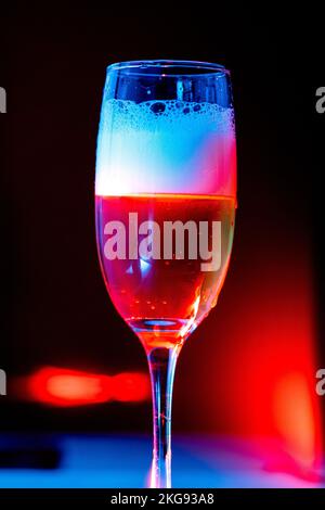 A vertical image of a glass of Champaign in the dark background with ...