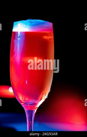 A vertical image of a full glass of Champaign in the dark background ...