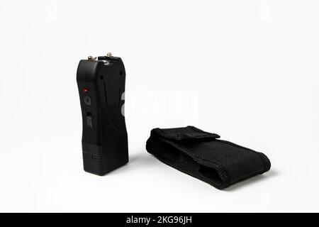Black electric shocker and flashlight with a bag on a white background ...