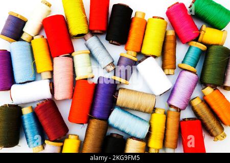 Multi-color silk thread coils on white background Stock Photo - Alamy