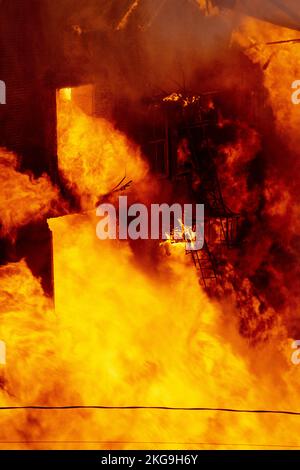 Fire disaster in a warehouse. Fire fighting in an industrial area. Red ...