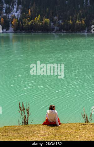 Lone tourist sitting at Issyk Lake, South Kazakhstan, Central Asia ...