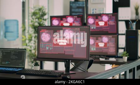 Computers displaying critical error message flashing on screen, showing hacking alert and ...