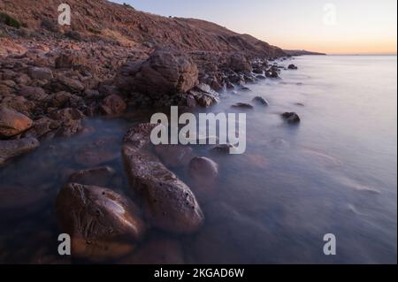 The smooth rock formations of the coast at Hallet Cove at sunset ...