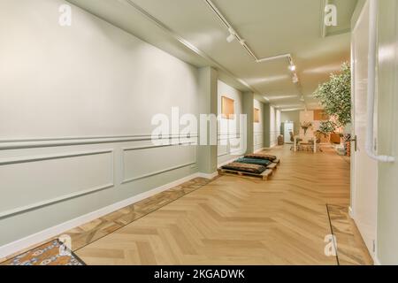 Table with chairs and flowers located near lounge area and kitchen in ...