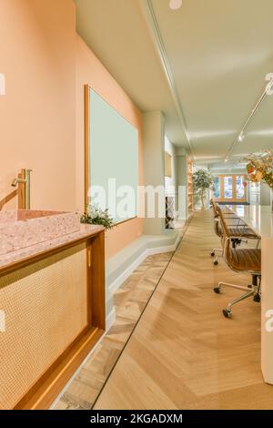 Table with chairs and flowers located near lounge area and kitchen in ...