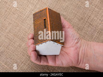 Little model house in hand in a paper box Stock Photo - Alamy