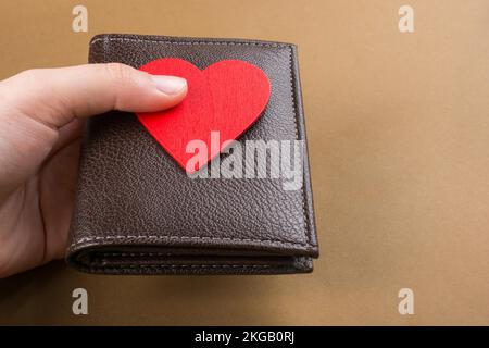 Brown leather wallet in hand saving and finance concept Stock Photo - Alamy